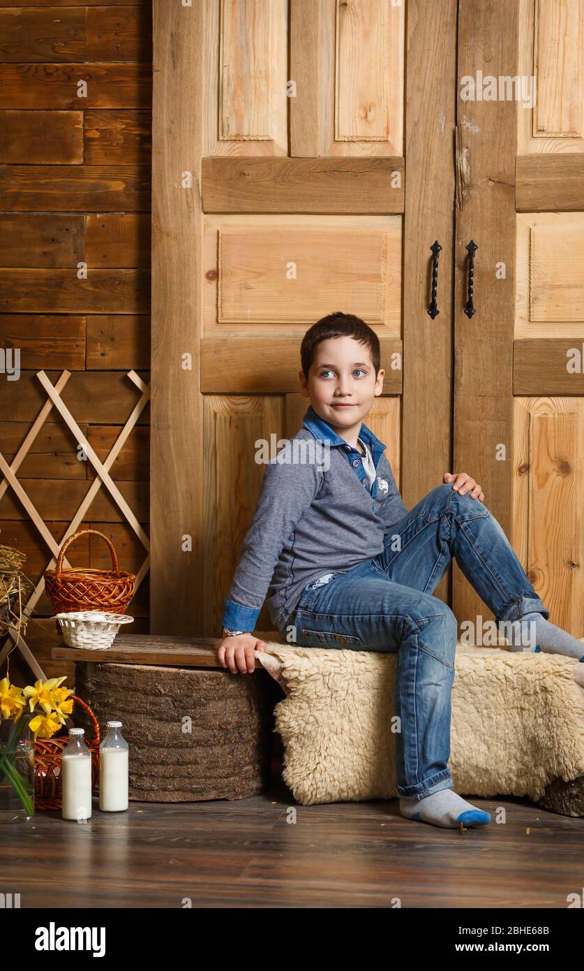Cute boy sitting on a bench Stock Photo - Alamy