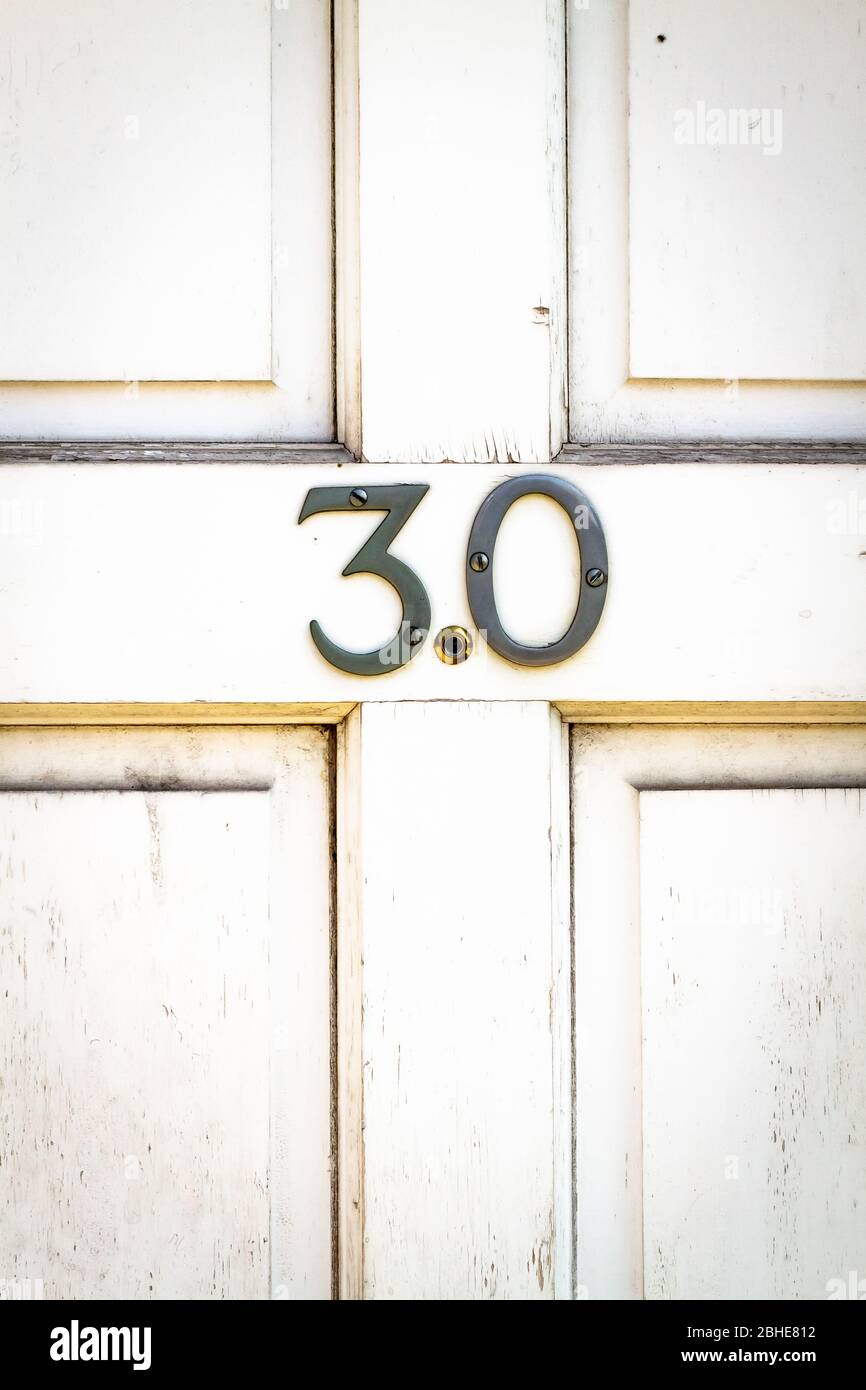 House number 30 on a dusty white wooden front door Stock Photo - Alamy