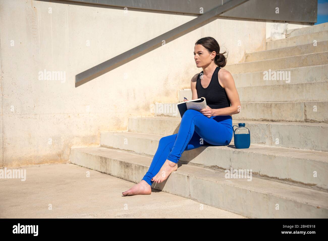 Woman sitting barefoot on steps hi-res stock photography and images - Alamy