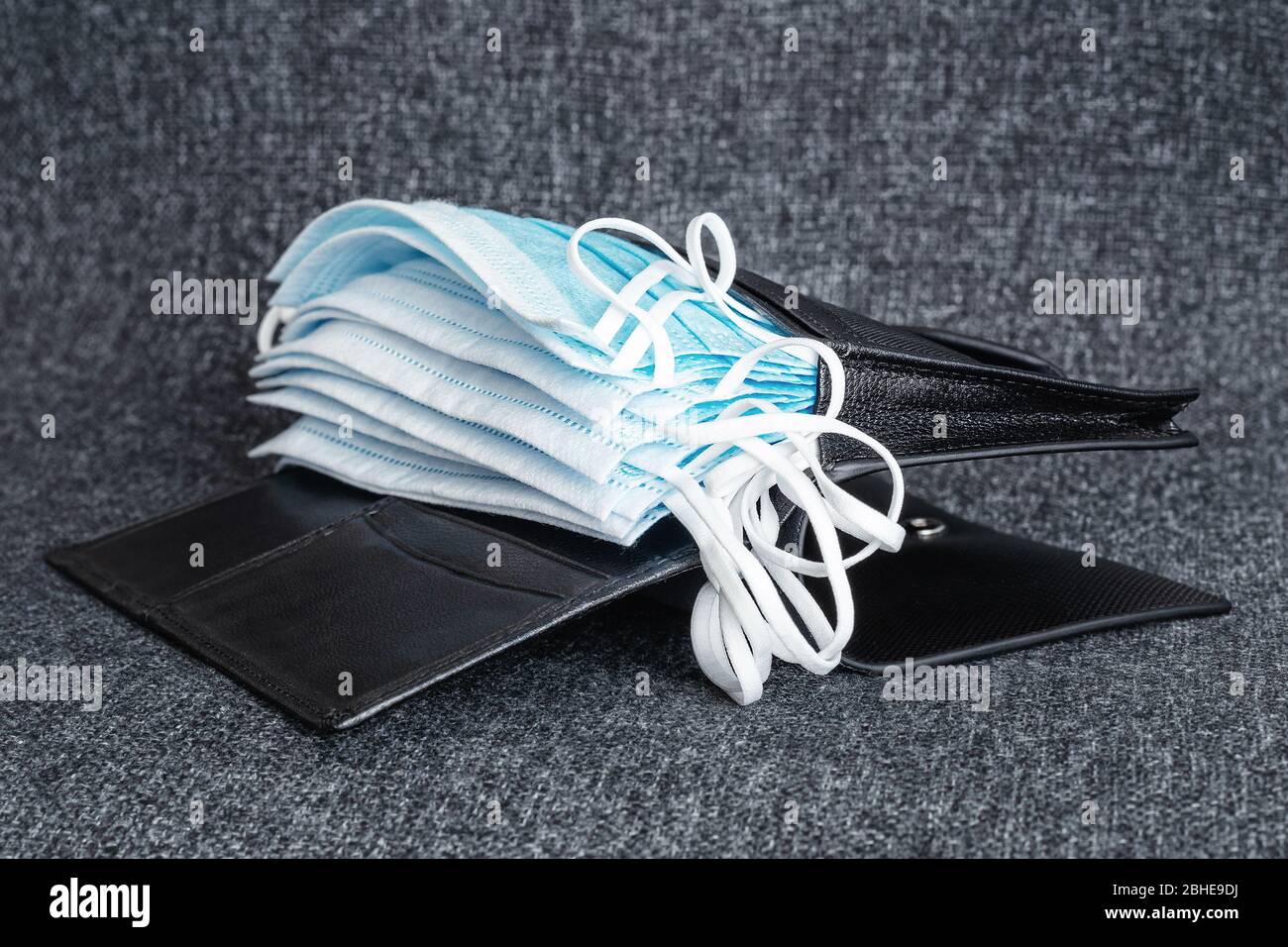 Surgical face masks in a wallet (concept: the value of face masks ...