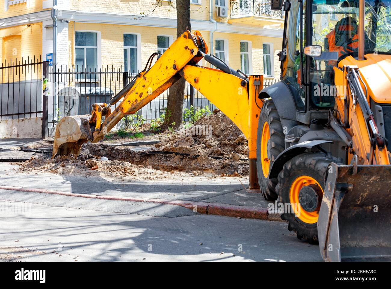 The bucket and arrow of a heavy road excavator dig a trench on the ...