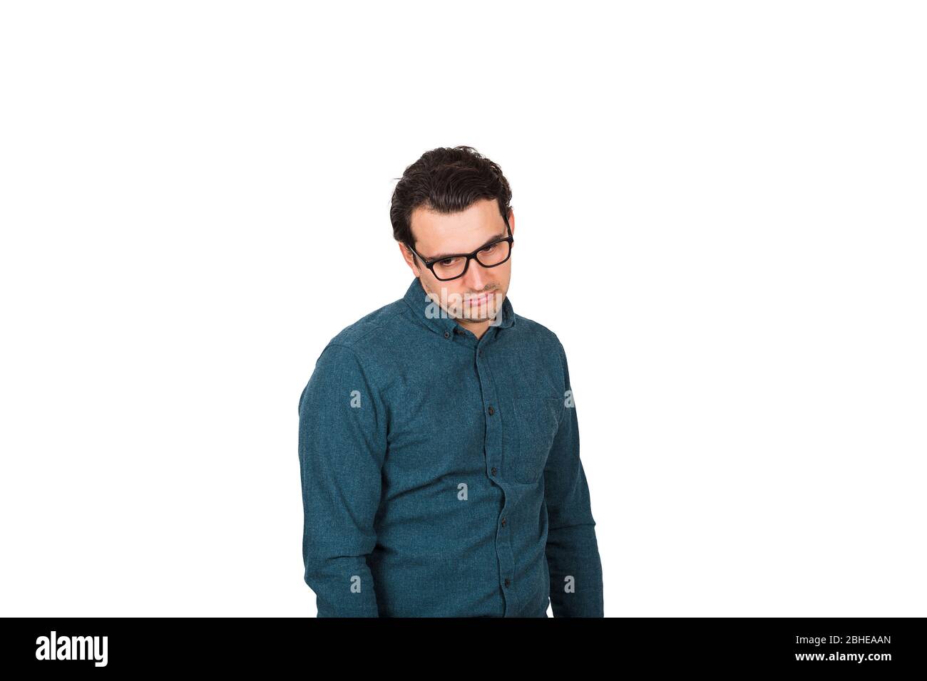 Tired and annoyed businessman makes a displeased facial expression ...