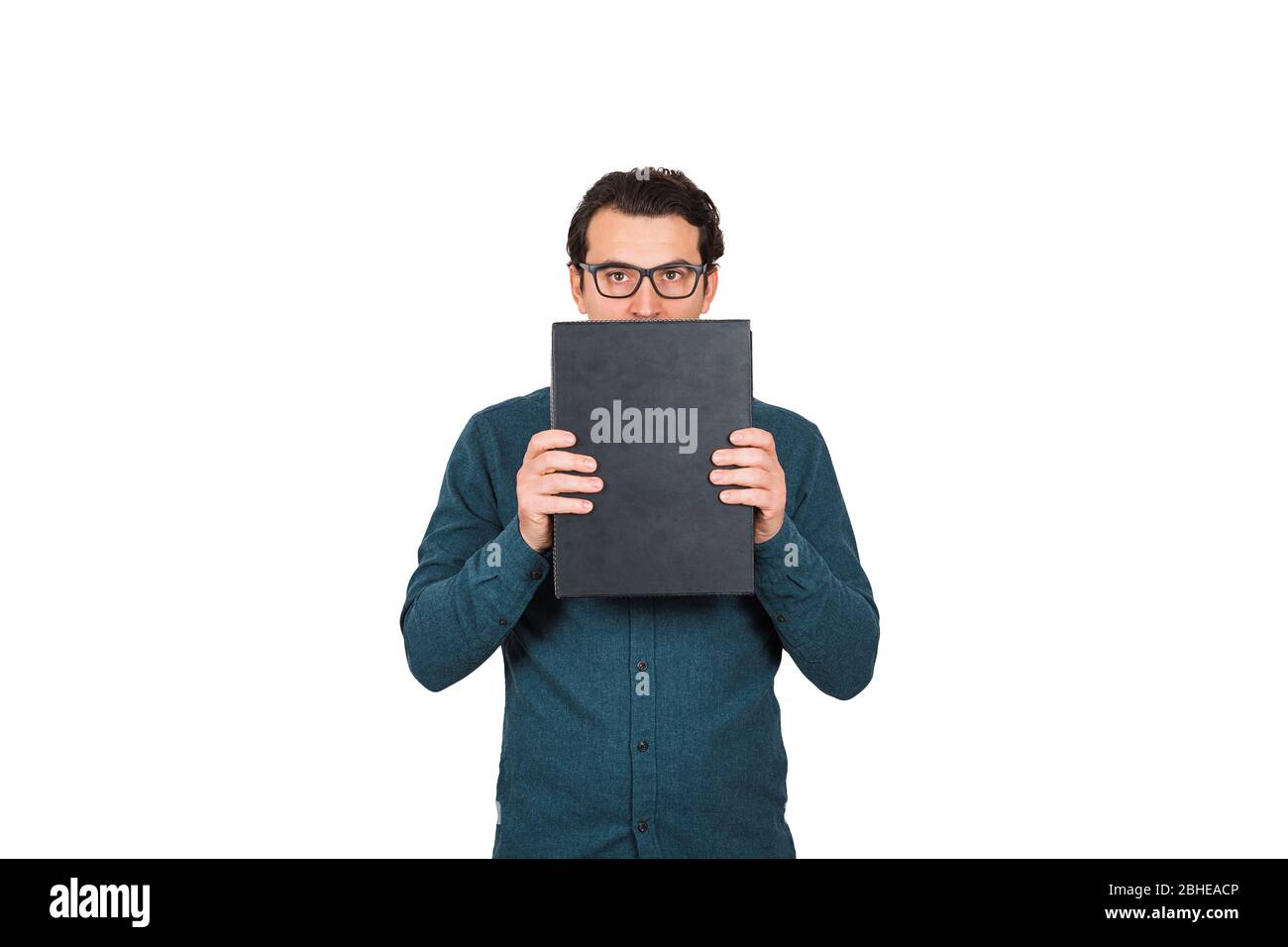Introvert businessman looking to camera, covers his mouth using ...