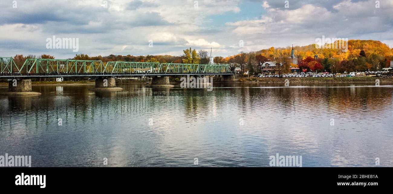Panoramic fall scene of a bridge across the Delaware River from Bucks ...