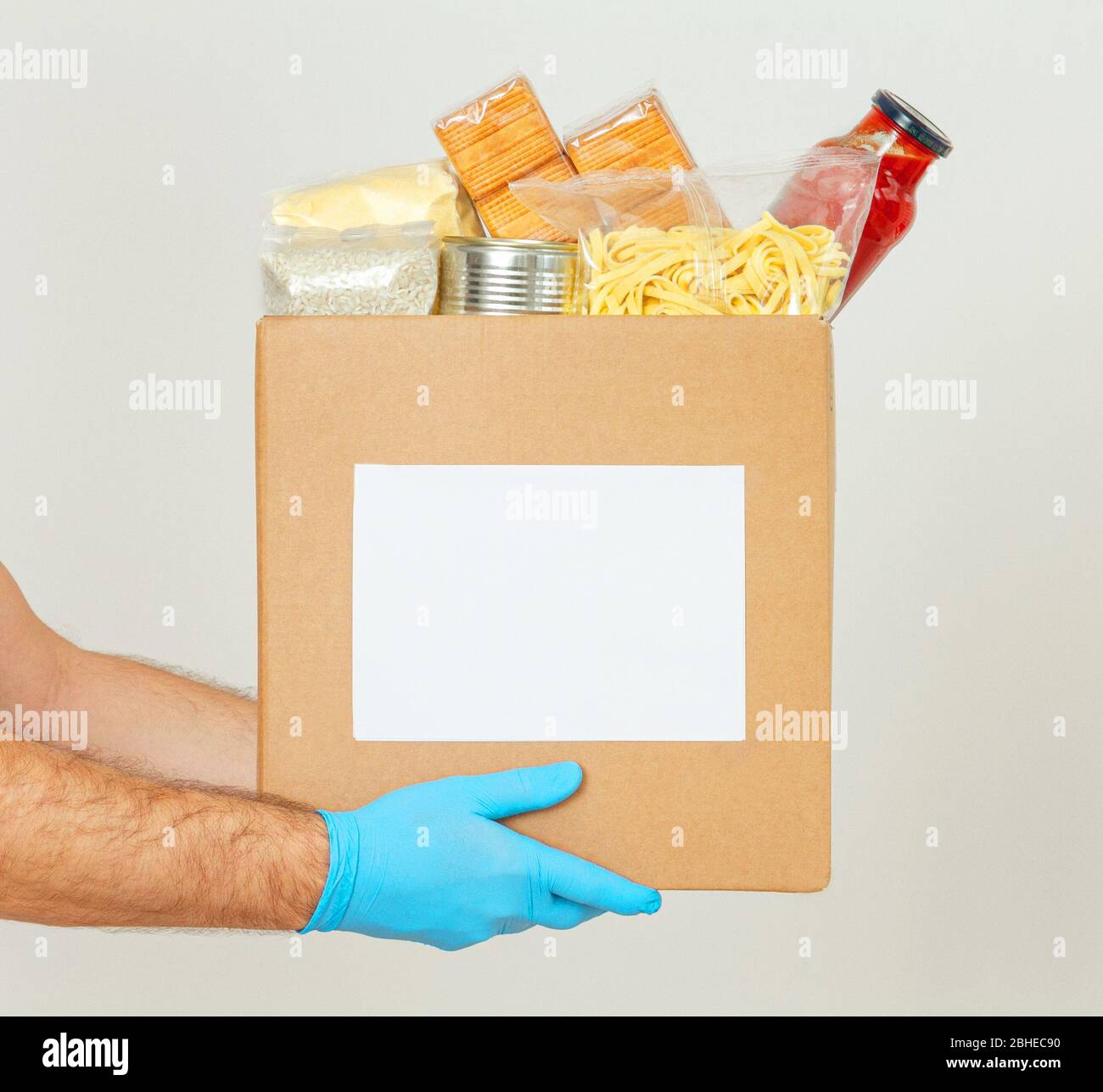 Donation box. Delivery food. Volunteer. Food help. A men's hands in ...