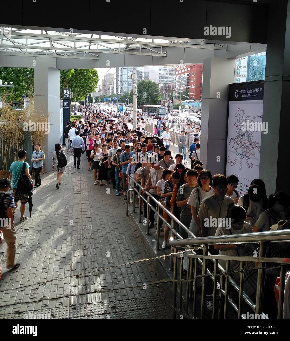Crowd of Chinese people in a row entering the metro station in Beijing ...