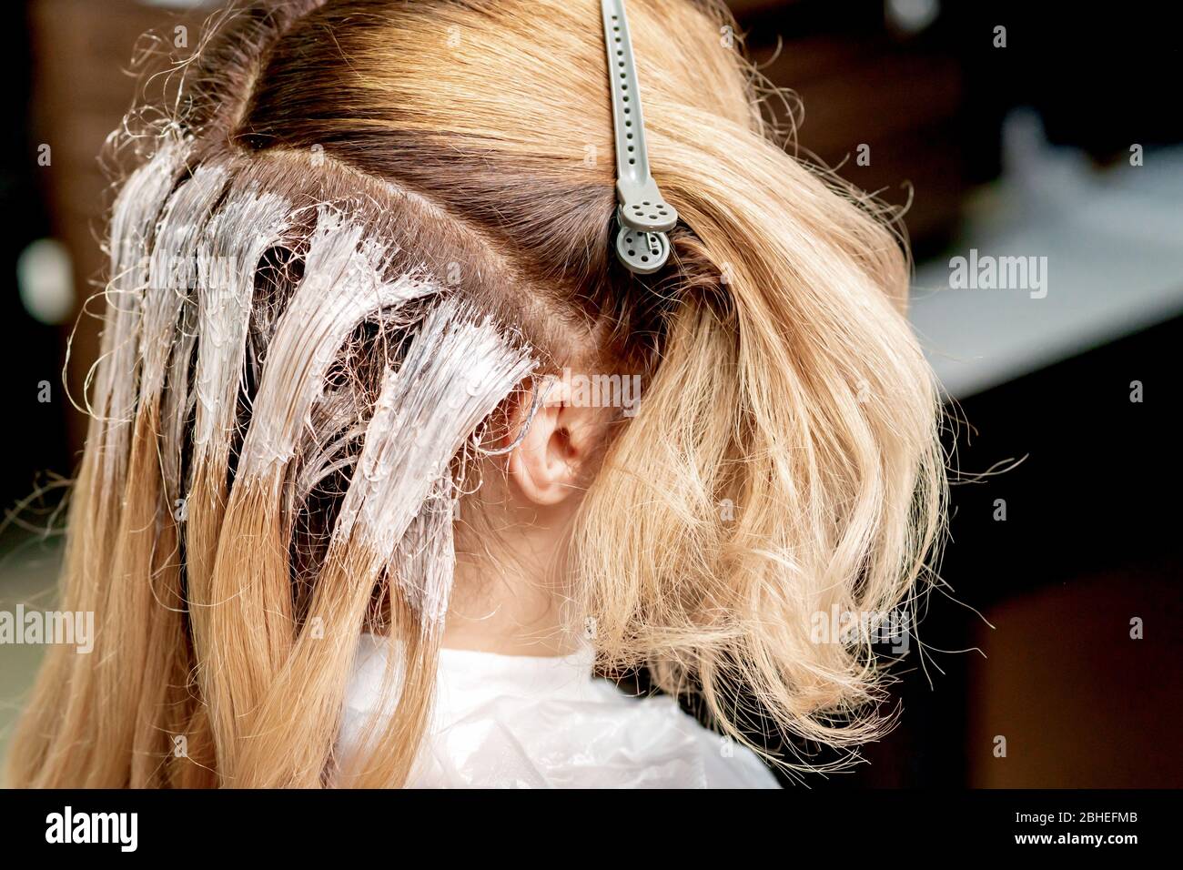 Close up dye on hair of woman during process of dyeing hair in hair ...