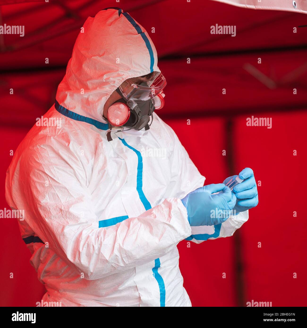 Medical staff with face mask and professional uniform sticks sample ...