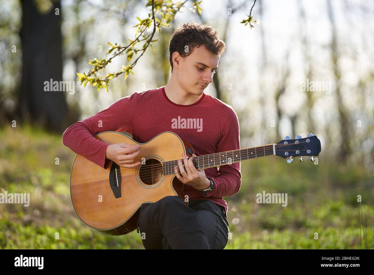 Young man playing guitar outdoor Stock Photo - Alamy