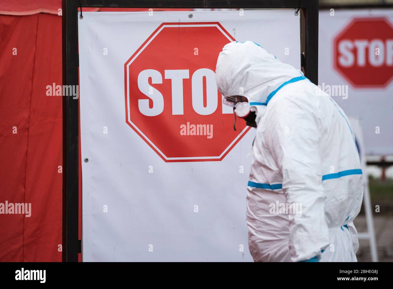 Employee of the medical laboratory and inscription "STOP" at the point ...