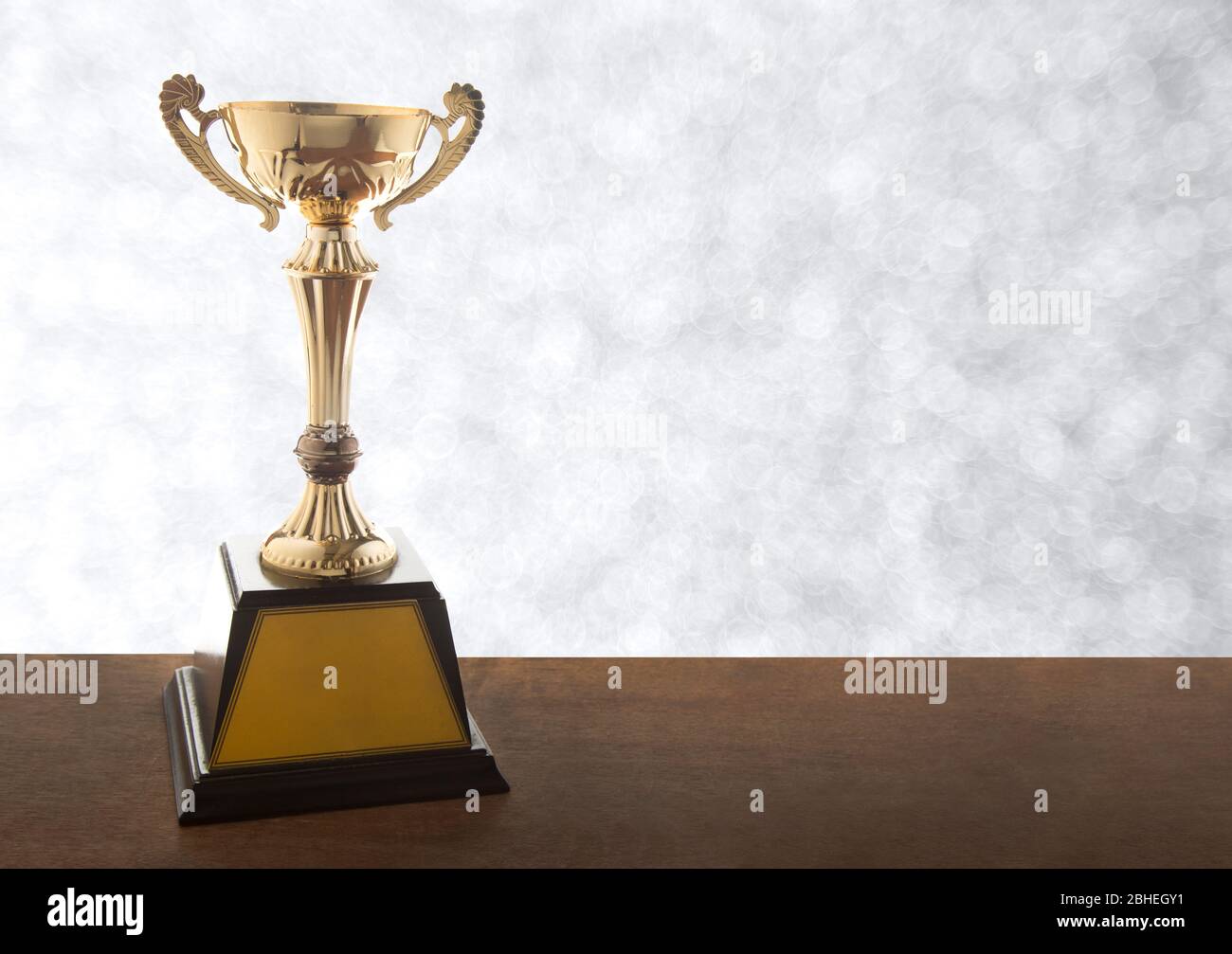 Gold trophy on wooden hi-res stock photography and images - Alamy
