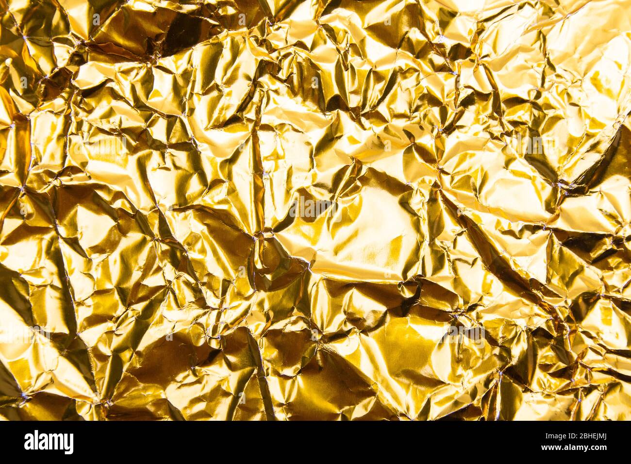 Gold crumpled foil paper texture background Stock Photo - Alamy
