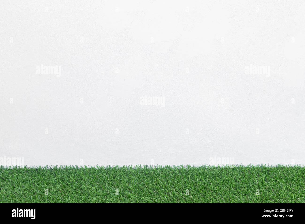 Green grass floor with white concrete background, Mockup for design ...