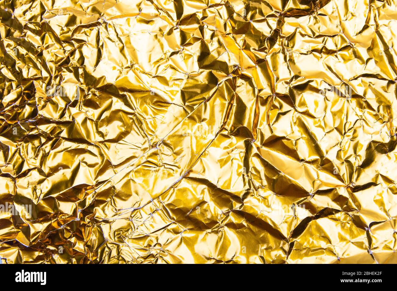 Gold crumpled foil paper texture background Stock Photo - Alamy