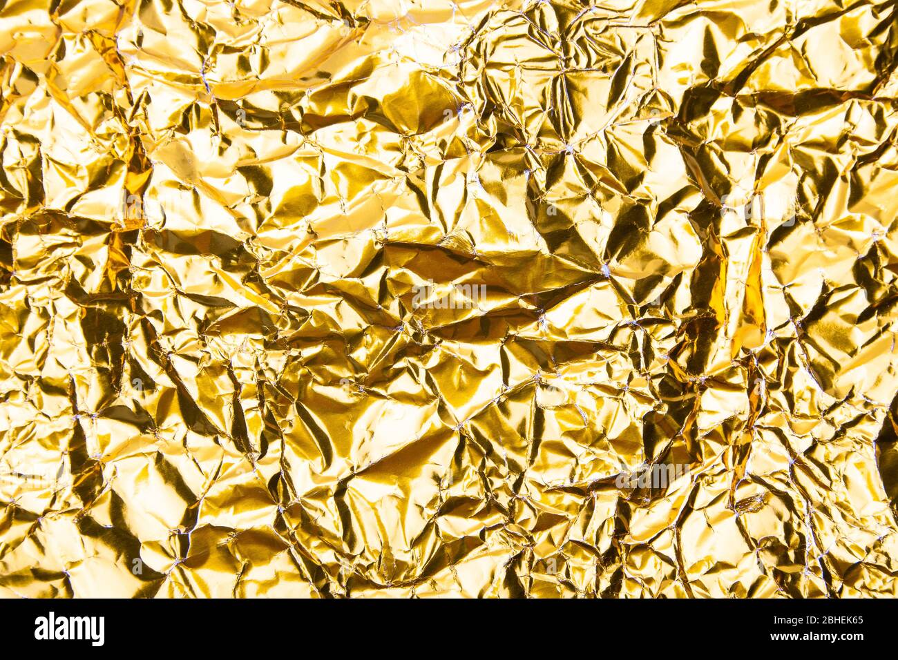 Gold crumpled foil paper texture background Stock Photo - Alamy