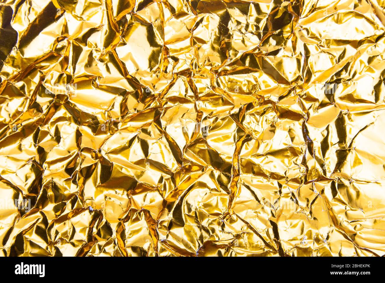 Gold crumpled foil paper texture background Stock Photo - Alamy