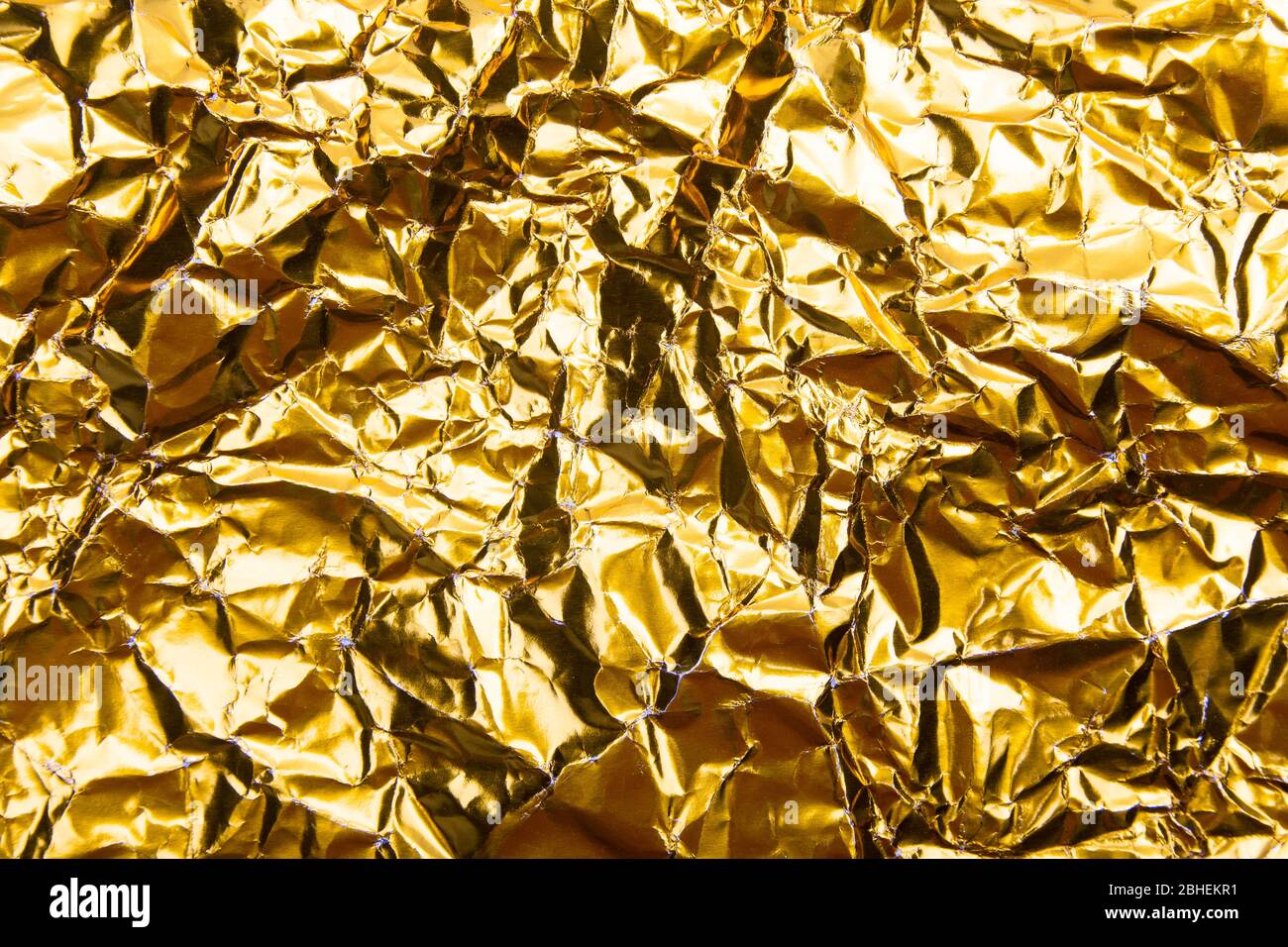 Gold crumpled foil paper texture background Stock Photo - Alamy