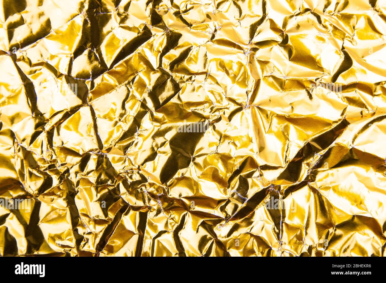 Gold crumpled foil paper texture background Stock Photo - Alamy