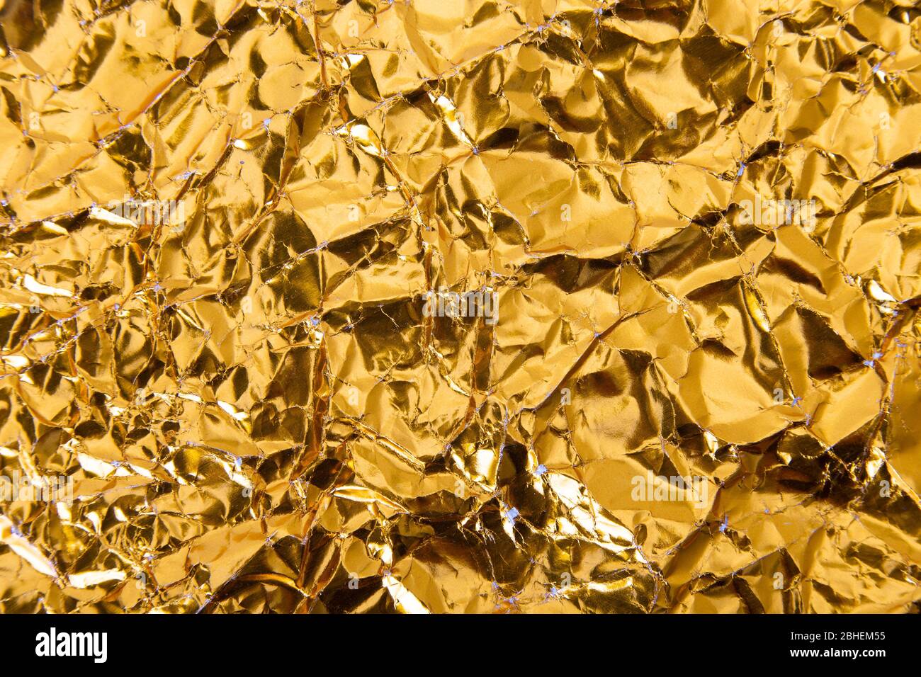 Gold crumpled foil paper texture background Stock Photo - Alamy