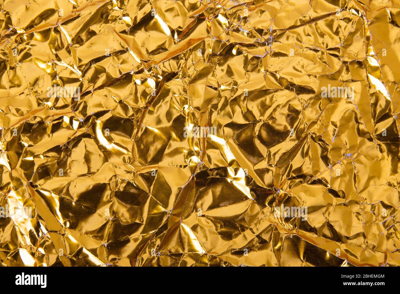 Gold crumpled foil paper texture background Stock Photo - Alamy