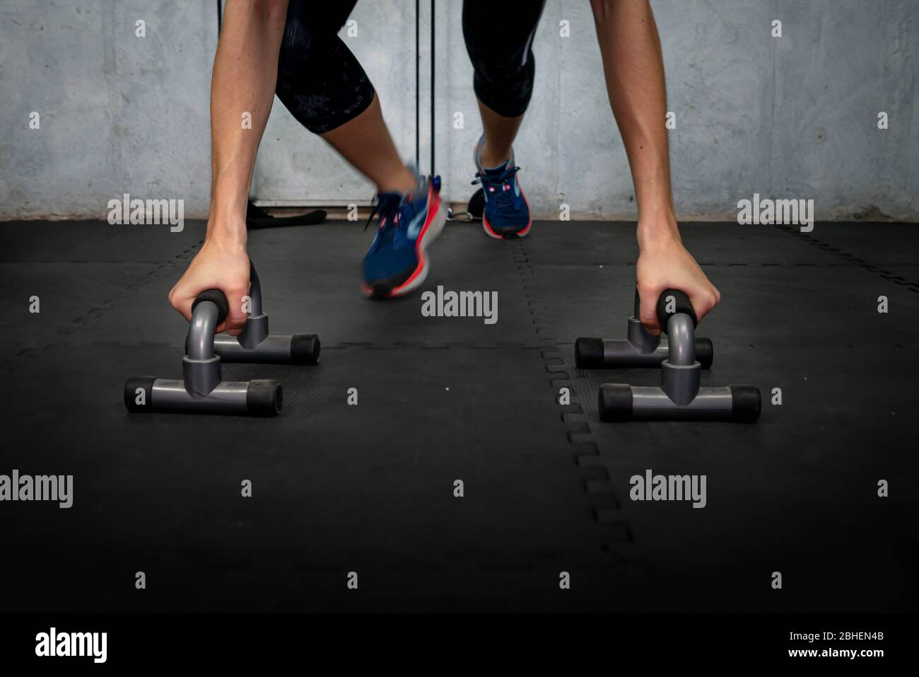 Young man exercises on the floor with parallel Stock Photo - Alamy