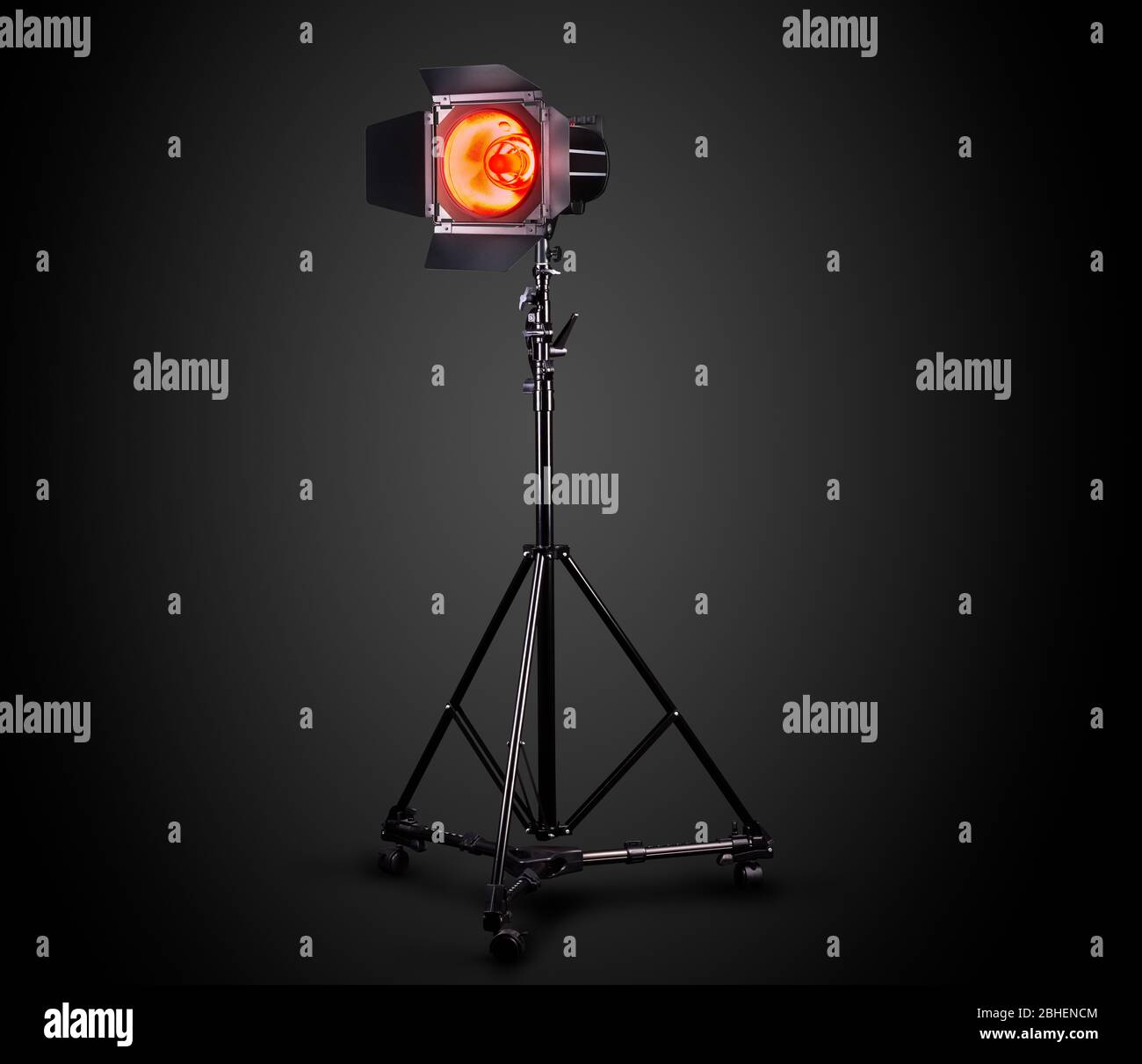 Photography studio flash on a lighting stand isolated on black ...