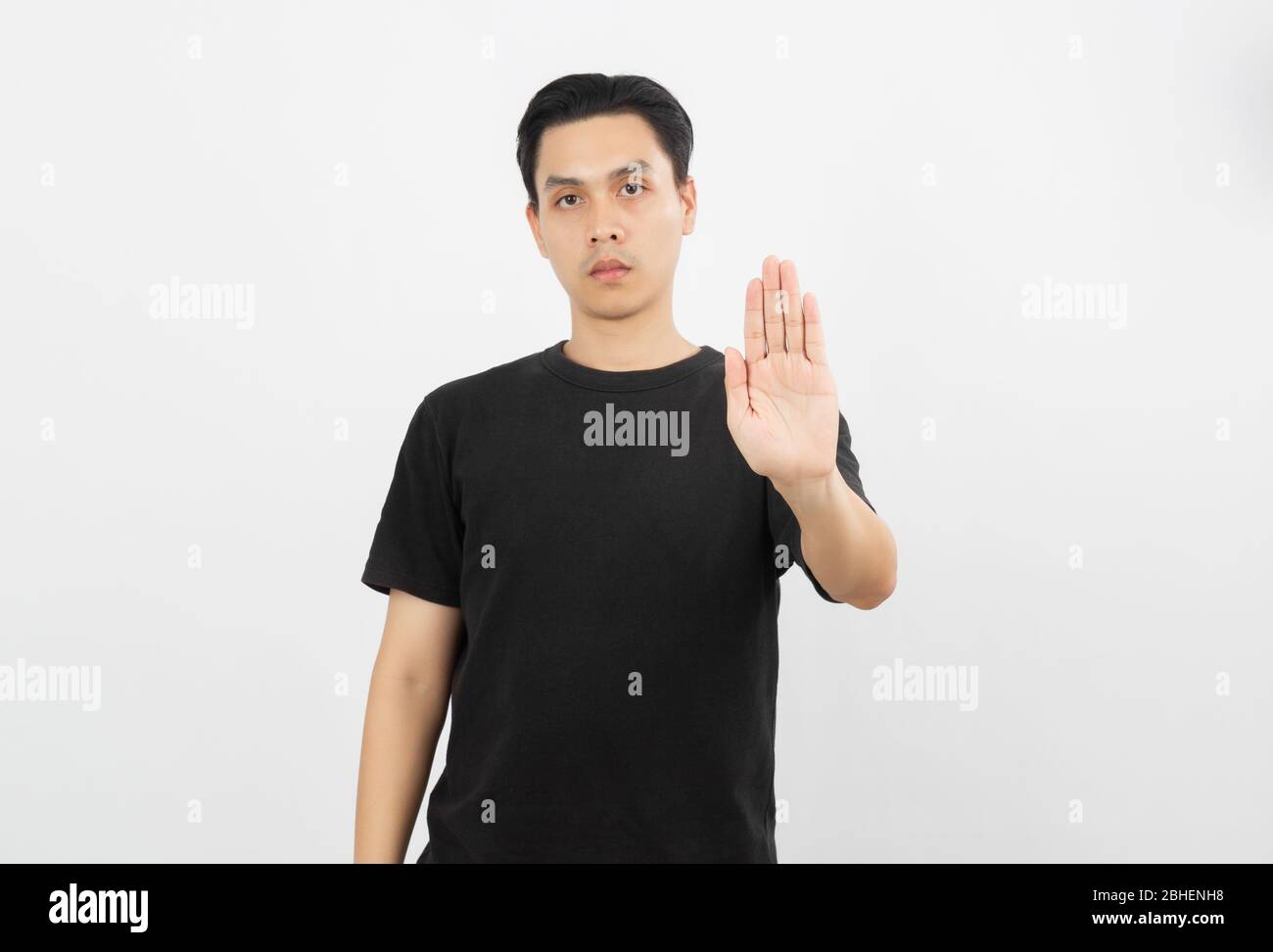 Young handsome asian man put hand up for stop isolated on white ...