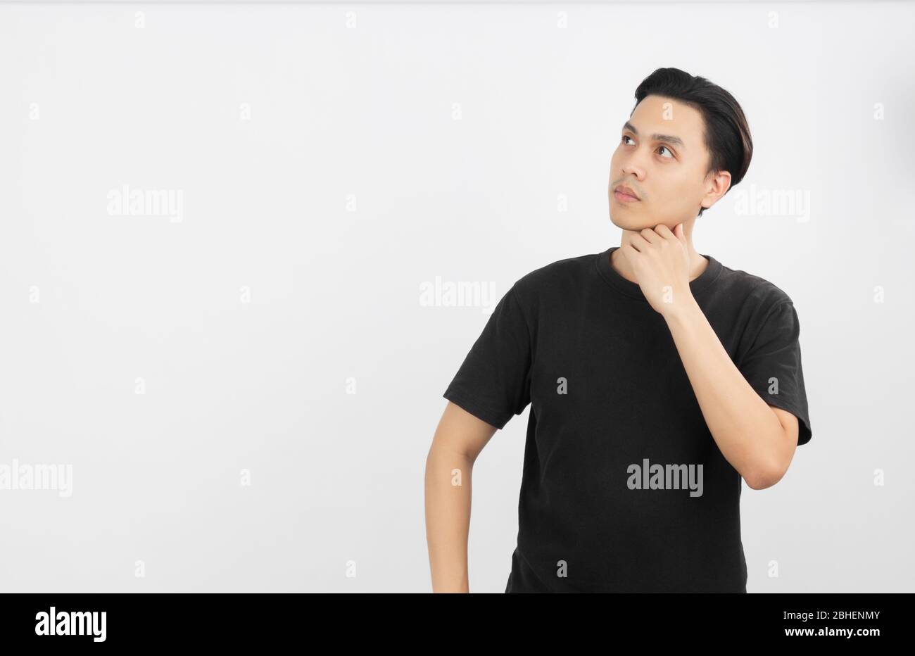 Young handsome asian man thinking an idea while looking up isolated on ...