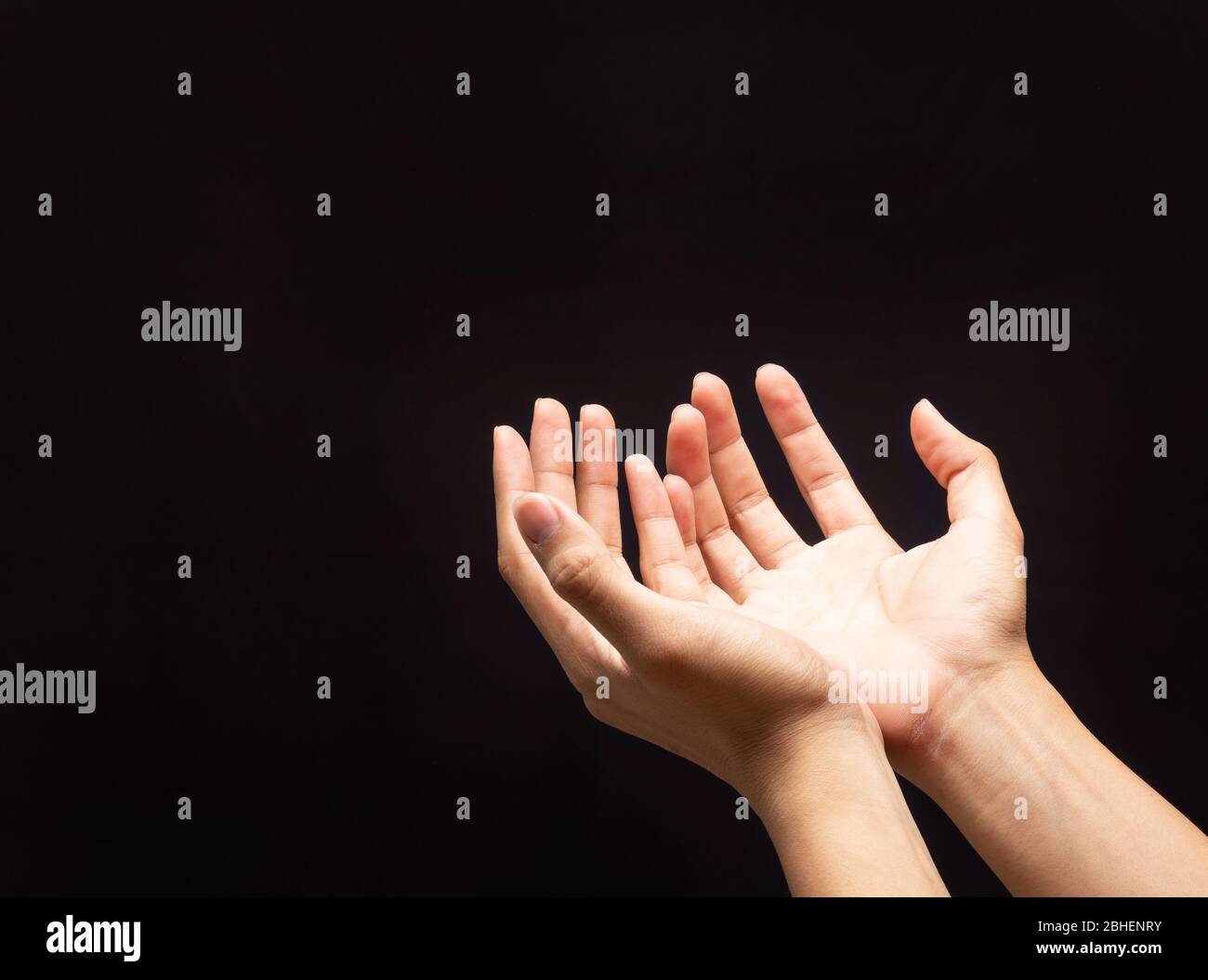 Praying hands in the dark background with faith in religion and belief ...