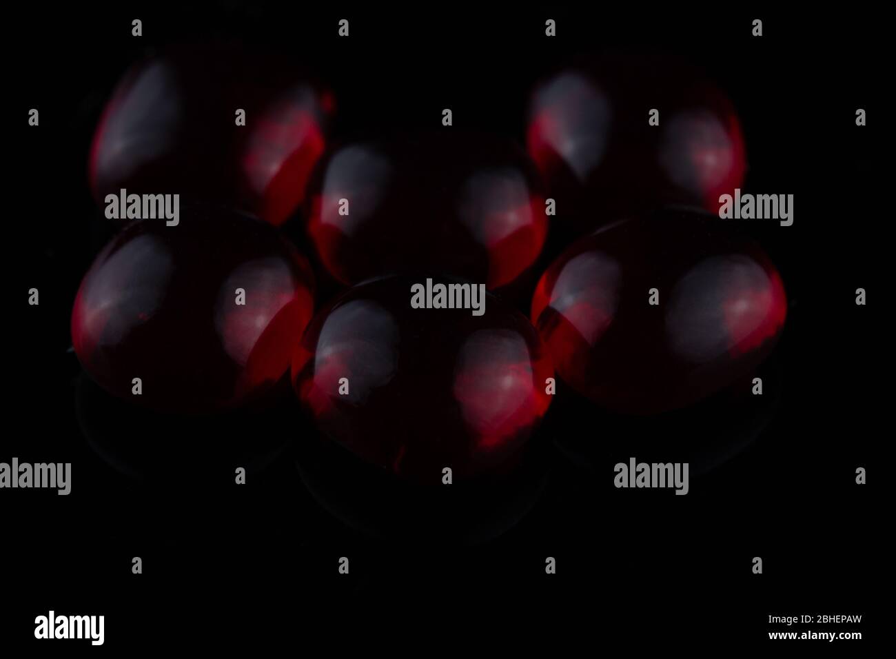 abstract digital illustration of red glass spheres on a black ...