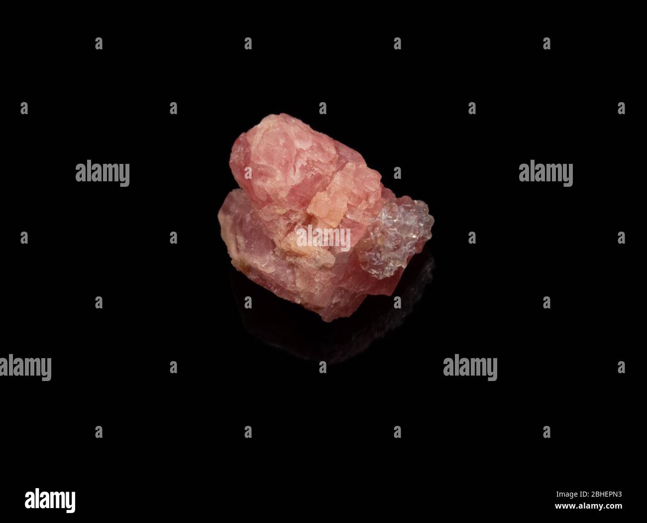 macro shot of raw specimen of rose quartz with inclusion growing on the ...