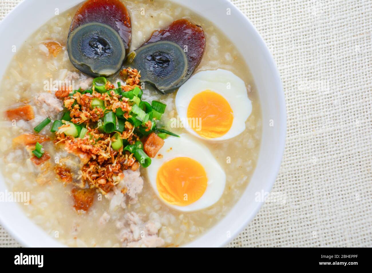Congee, Rice porridge with minced pork, boiled egg and century egg ...