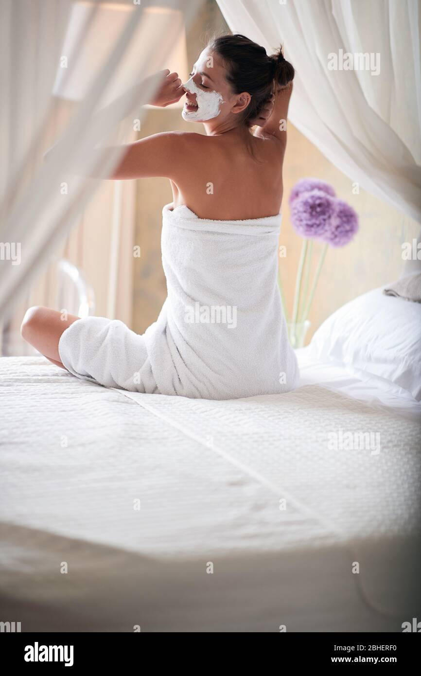 Beautiful smiling girl with facial mask enjoying at morning Stock Photo ...