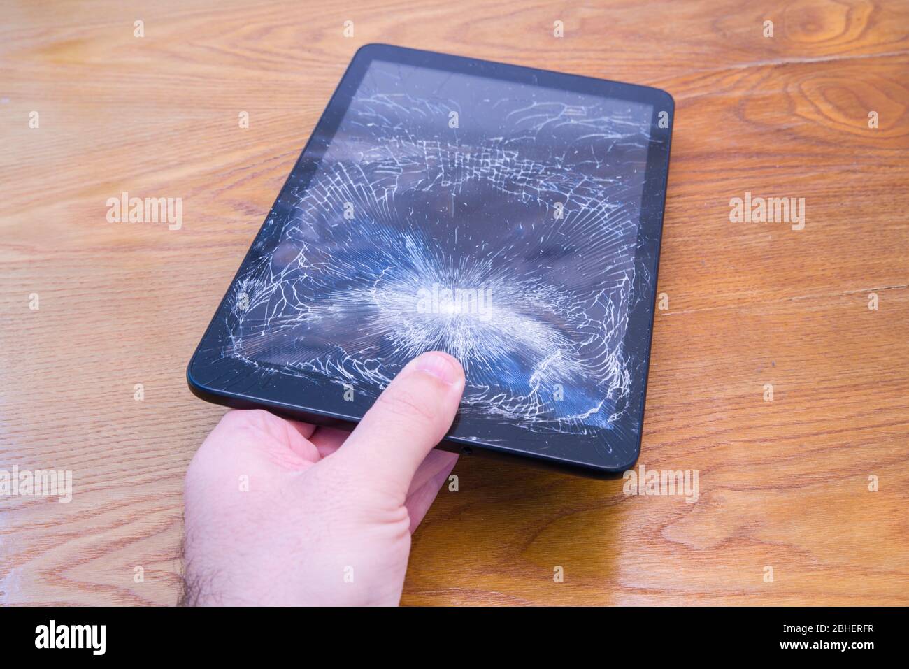 Hand holds a tablet with broken touchscreen, hard damaged display Stock ...