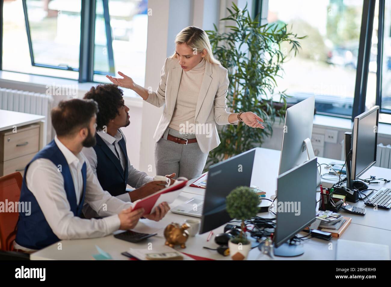 unsatisfied blonde caucasian female boss wondering, explaining and ...