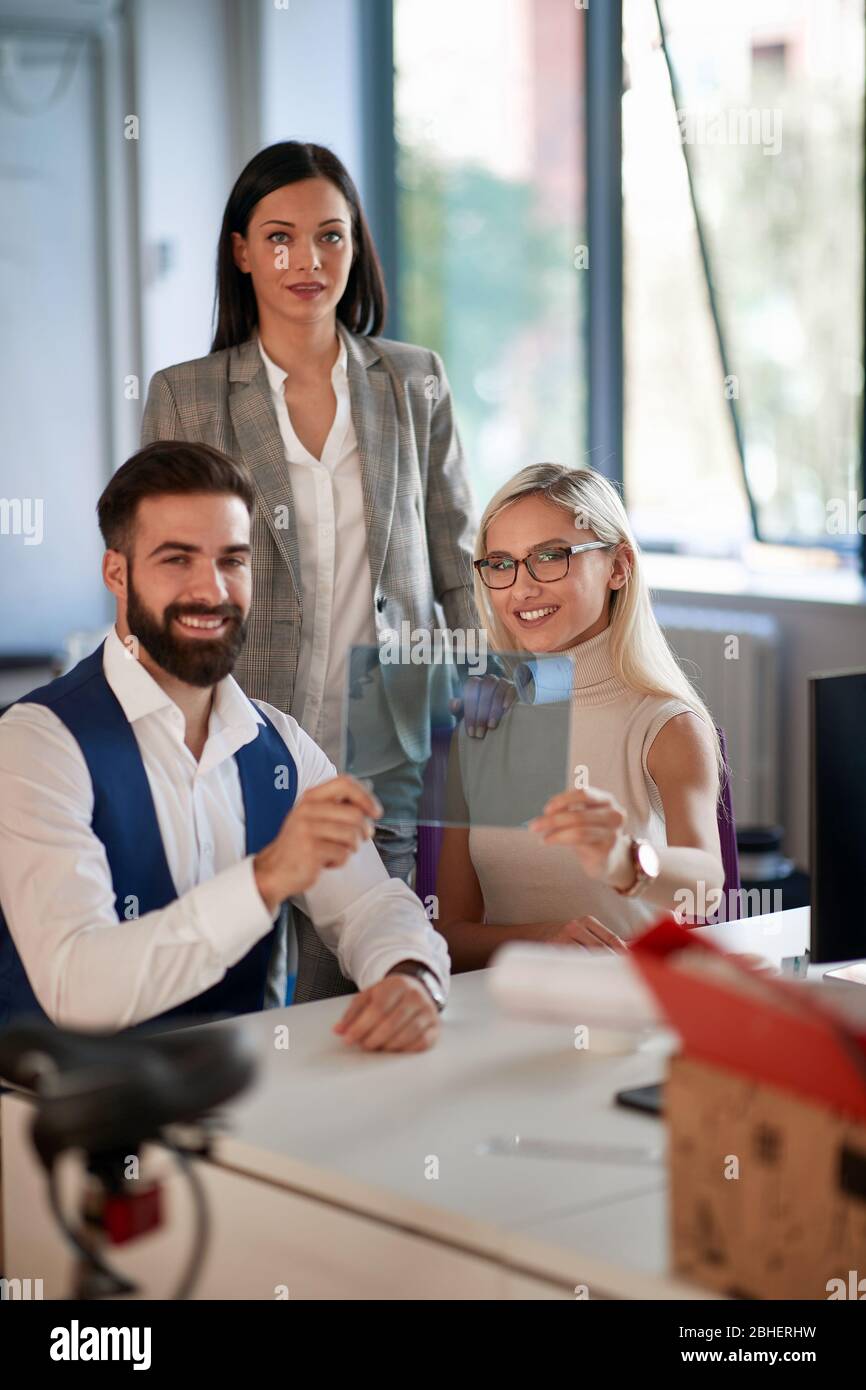 group of young business people showing future transparent tablet ...