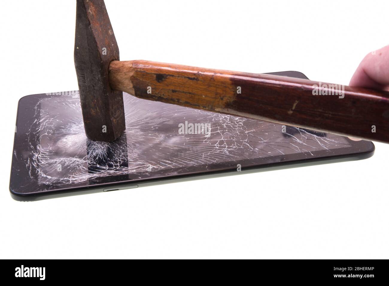 Hammer hitting a tablet screen, tablet destroyed Stock Photo - Alamy