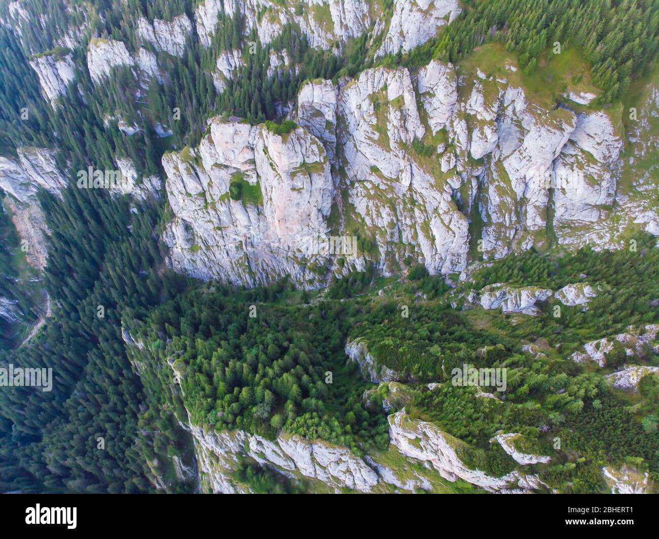 Above view of rocky mountain landscape, huge rocks and green forest in ...