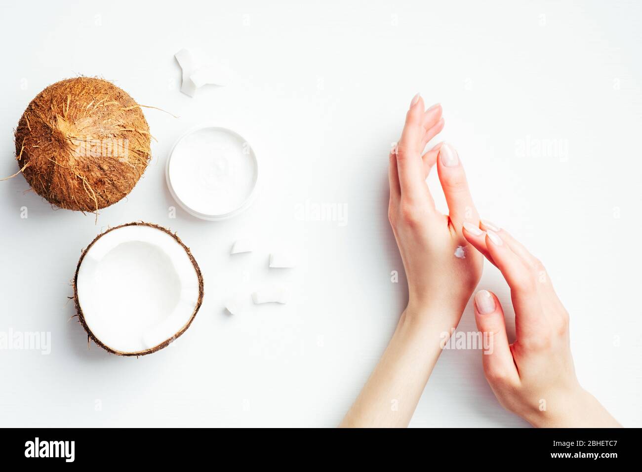 Female hands applying coconut cream on white background. Coconut ...