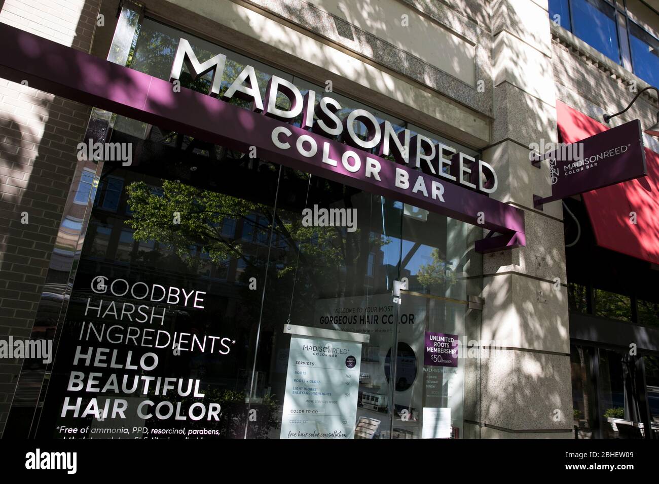 A logo sign outside of a Madison Reed Color Bar store location in ...