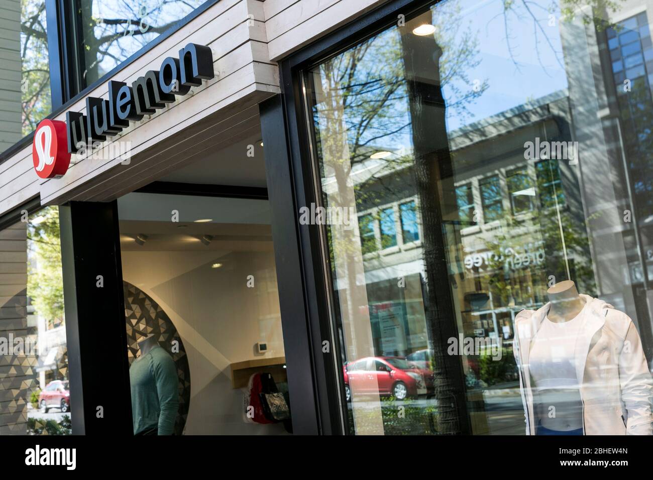 A logo sign outside of a Lululemon Athletica retail store location in ...