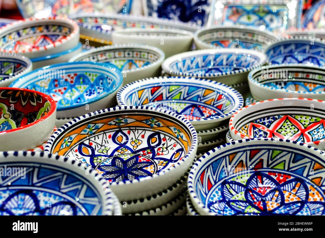 Many traditional asian handpainted porcelain plates on a market stall ...