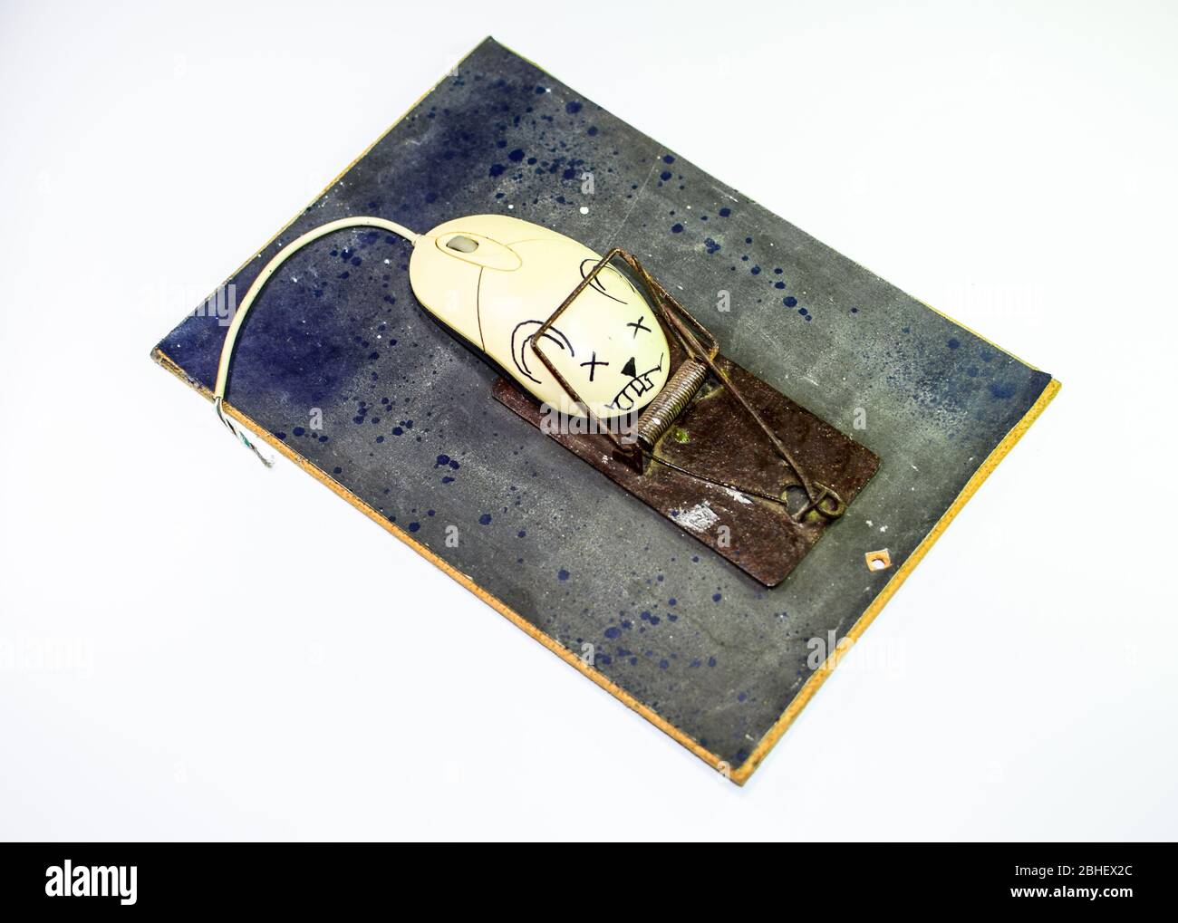 A computer mouse is a man in a mousetrap. Humorous collage in the ...