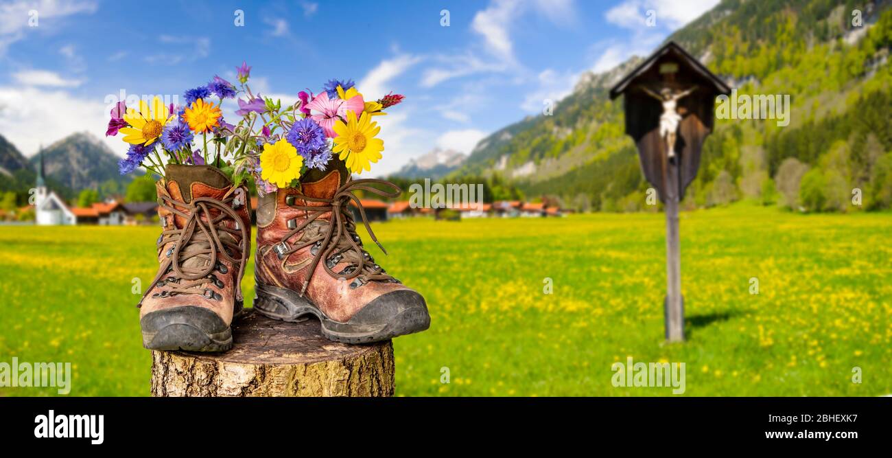 Walking shoes with flowers in a beautiful landscape Stock Photo - Alamy