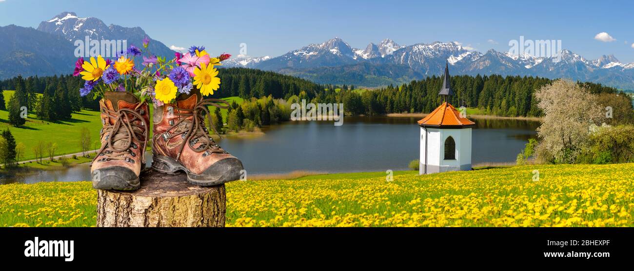 Walking shoes with flowers in a beautiful landscape Stock Photo - Alamy
