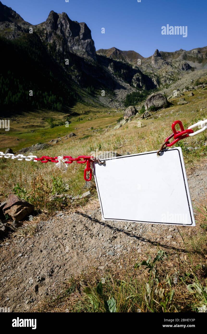 Mountain path signboard blocking the way with a chain Stock Photo - Alamy