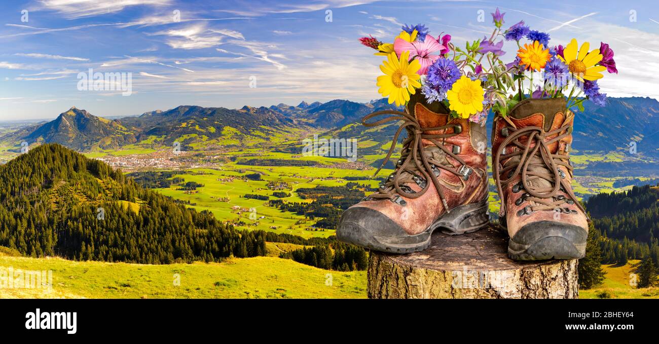 Walking shoes with flowers in a beautiful landscape Stock Photo - Alamy