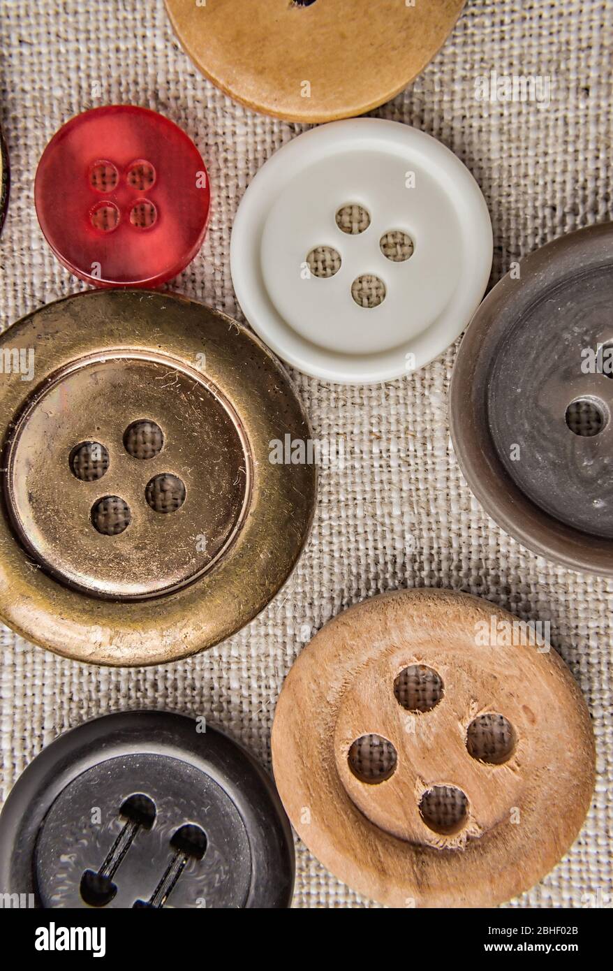 Sewing buttons of various sizes and colors on sackcloth Stock Photo - Alamy
