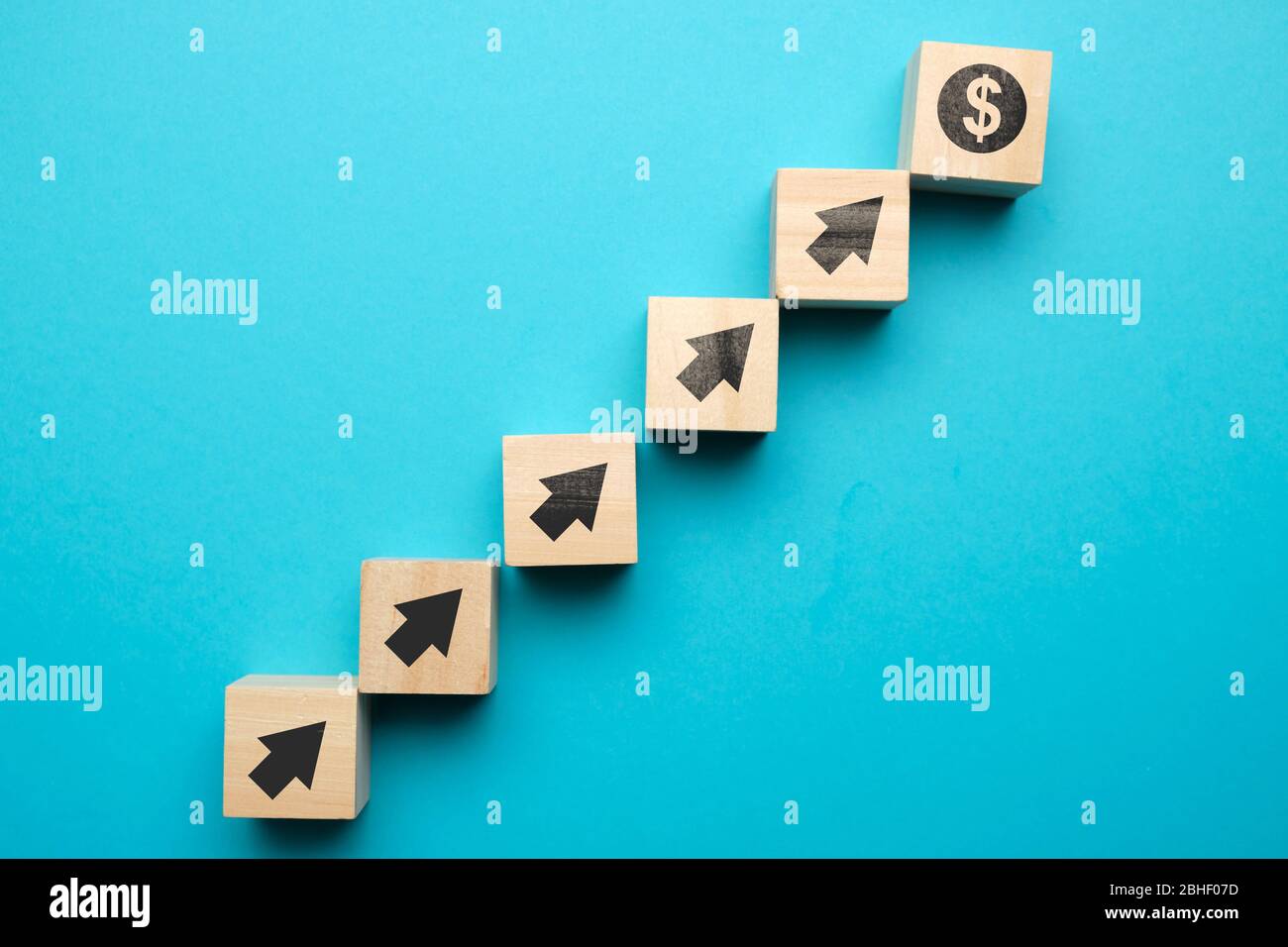Us dollar growth concept and with icons on wooden blocks. Close up ...