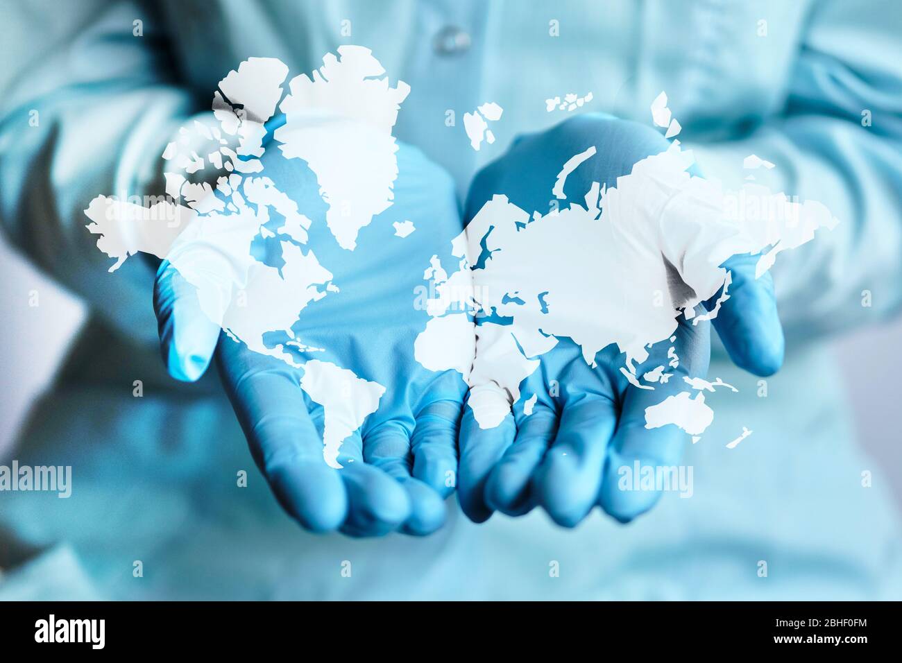 Abstract image of the world map on the hands of the doctor in medical ...